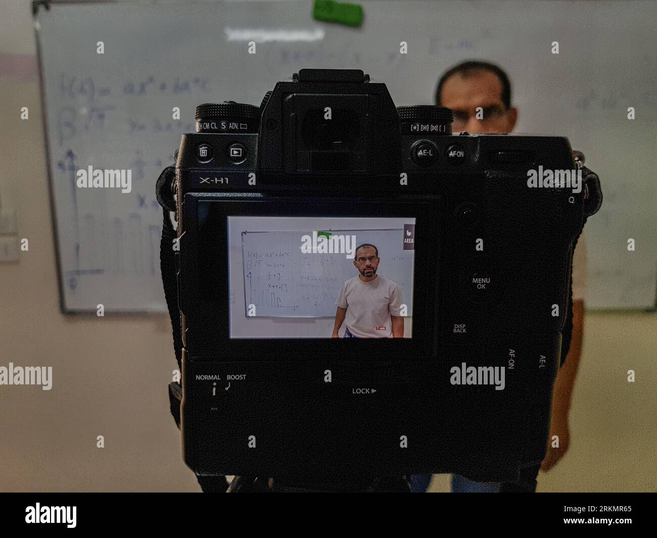 Teacher filming and streaming his lessons for the students through ...