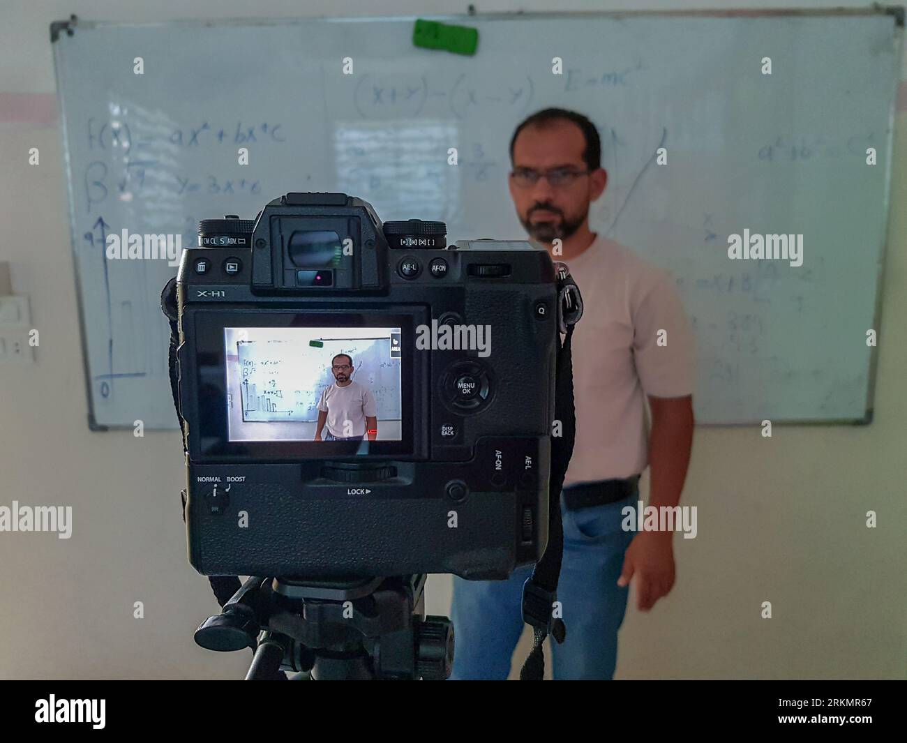 Teacher filming and streaming his lessons for the students through ...