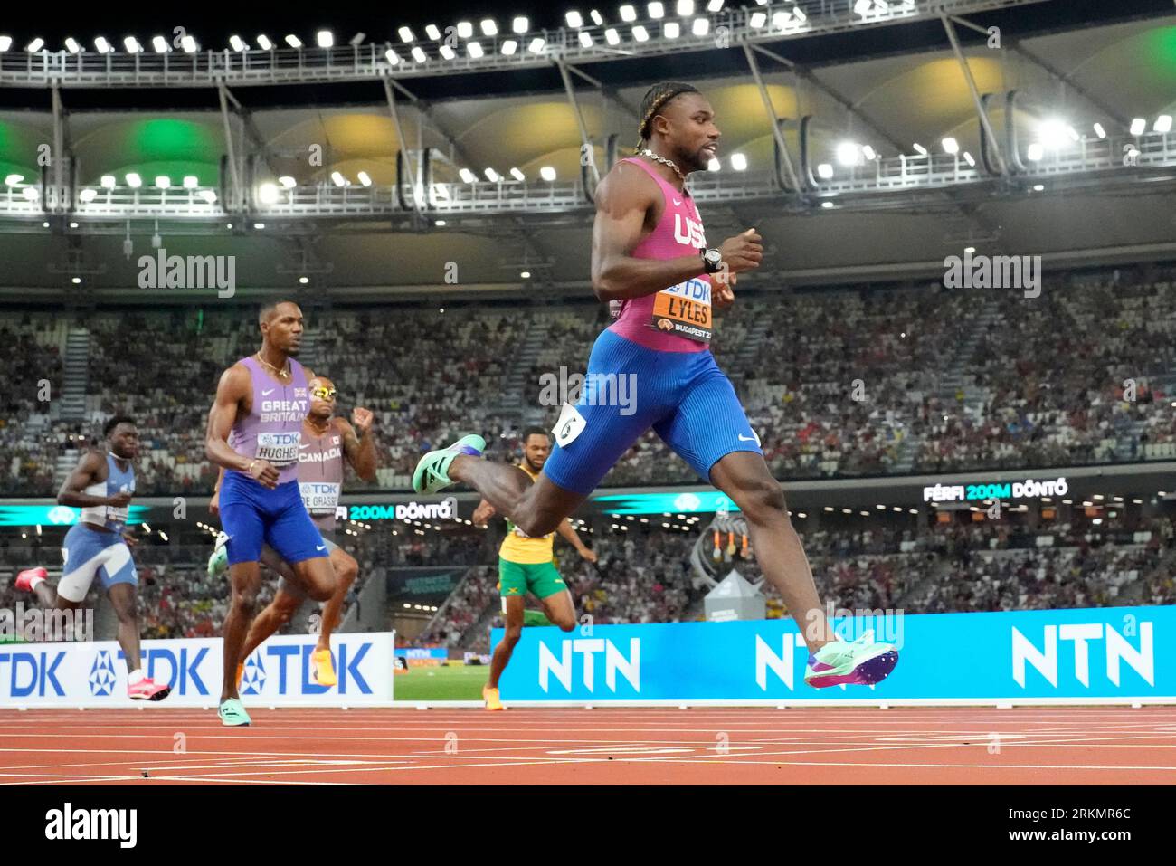 Noah Lyles, of the United States crosses the line to win the gold medal ...
