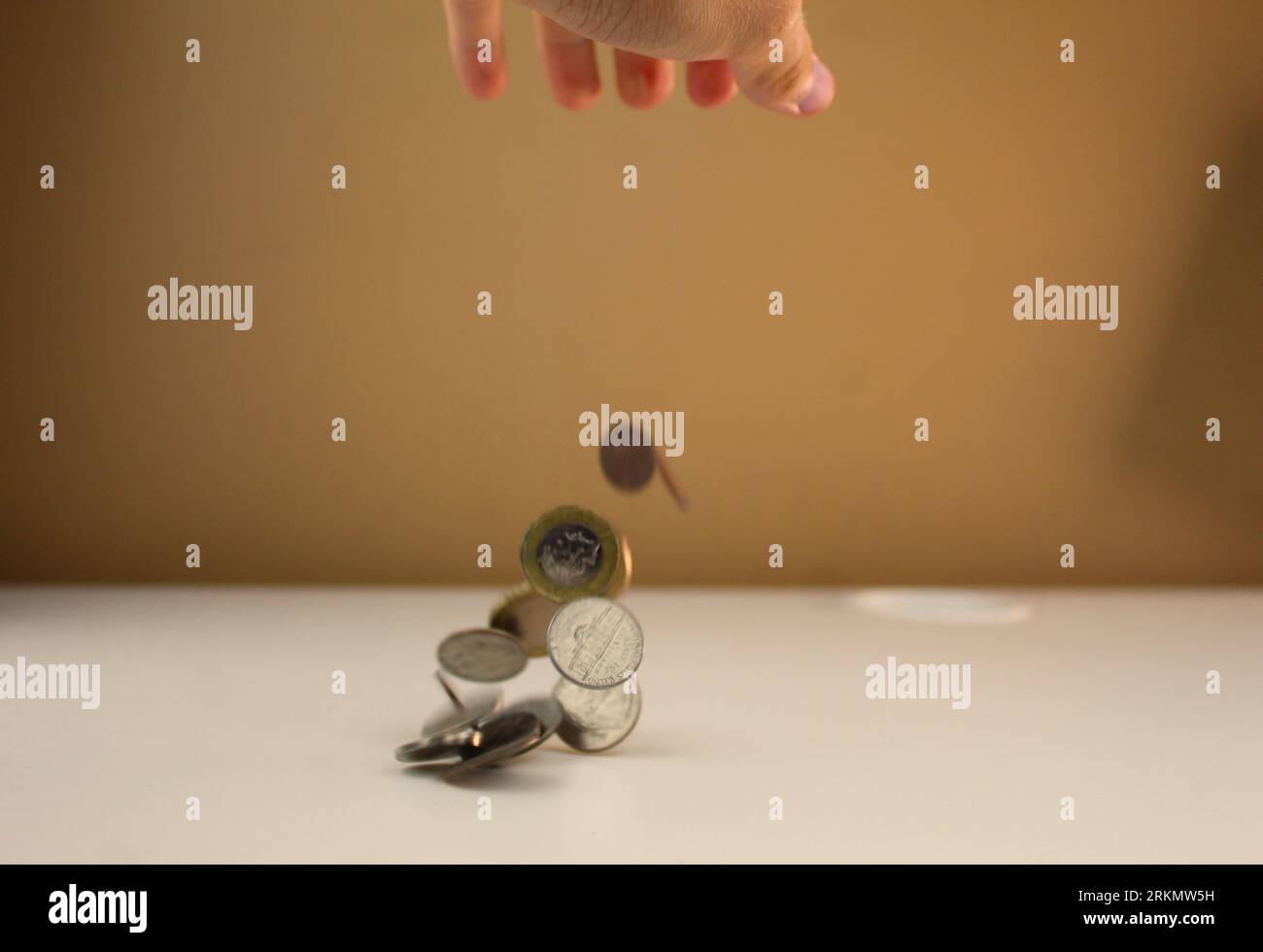 A hand dropping coins hi-res stock photography and images - Alamy