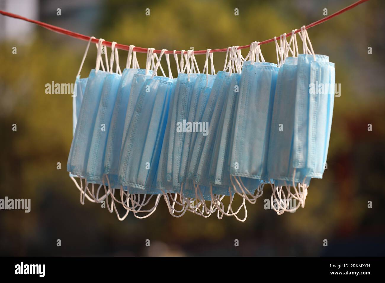 Face masks hanging Stock Photo - Alamy