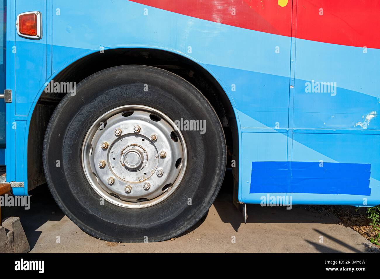 The front tire of a bus painted blue and red in Loa, Utah, USA Stock ...
