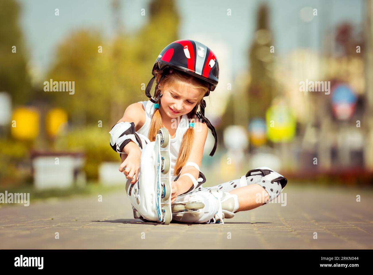 little cute happy little girl putting rollers Stock Photo - Alamy