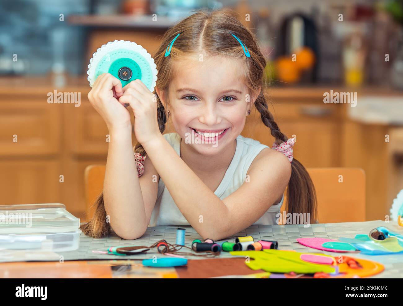 happy cute little girl shows materials for needlework Stock Photo - Alamy