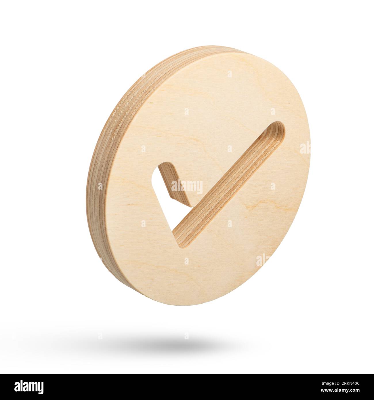 Check mark symbol on white isolated background. A large wooden round ...