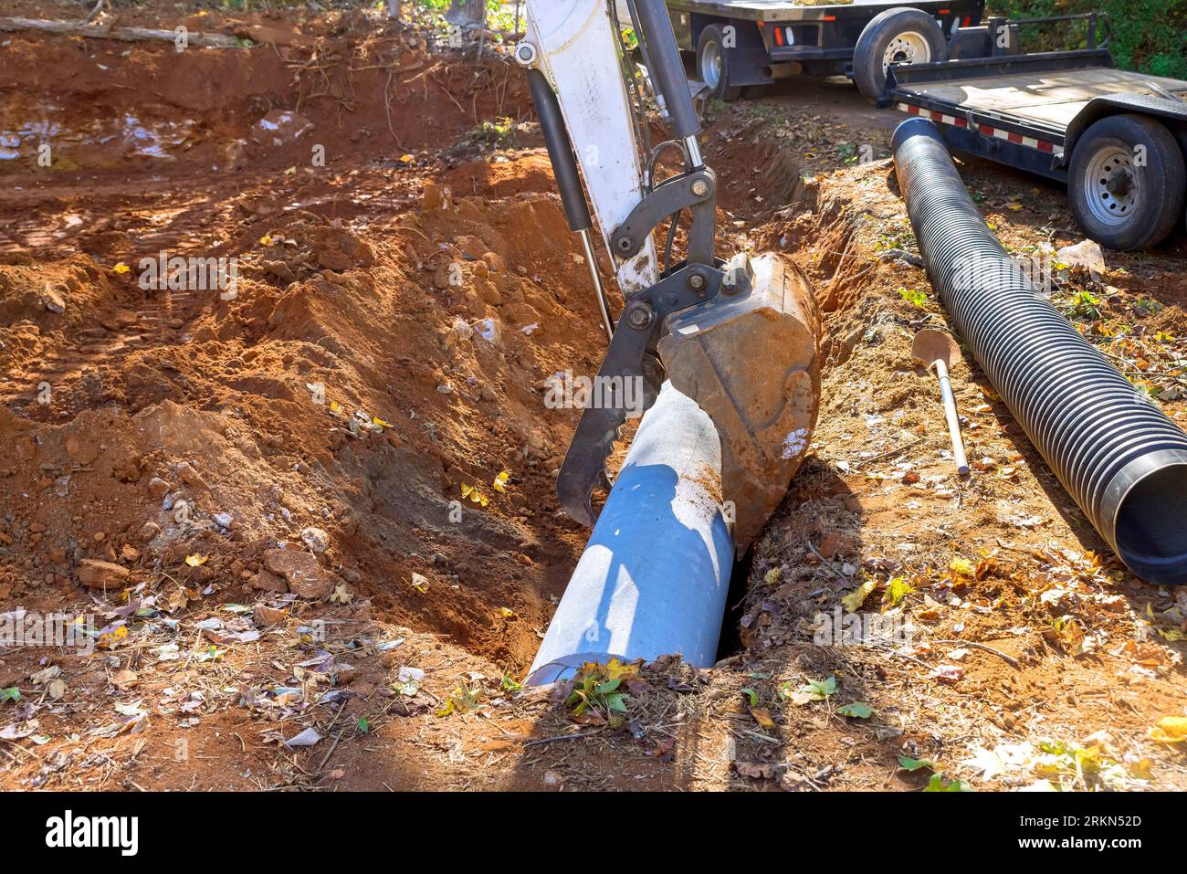 Ground work for underground worker uses tractor to installation ...