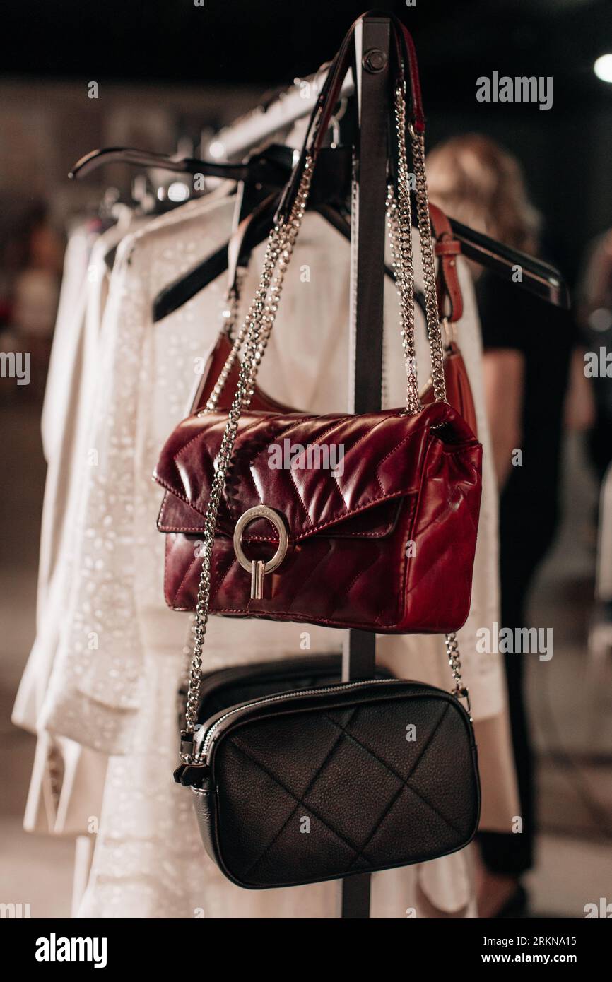 Women's white long dresses and black red handbags with silver chains ...