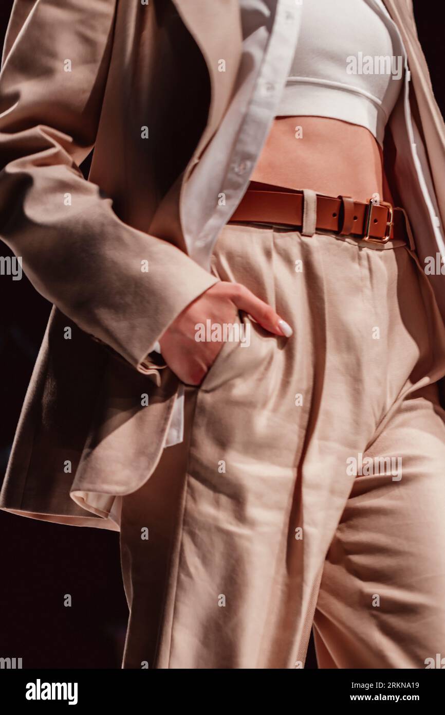 Figure of fashion model woman wearing beige classy costume, pants and ...