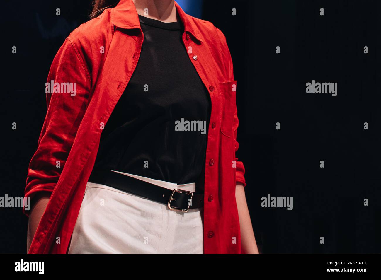 Classy white pants, black top and red shirt with buttons on female body ...