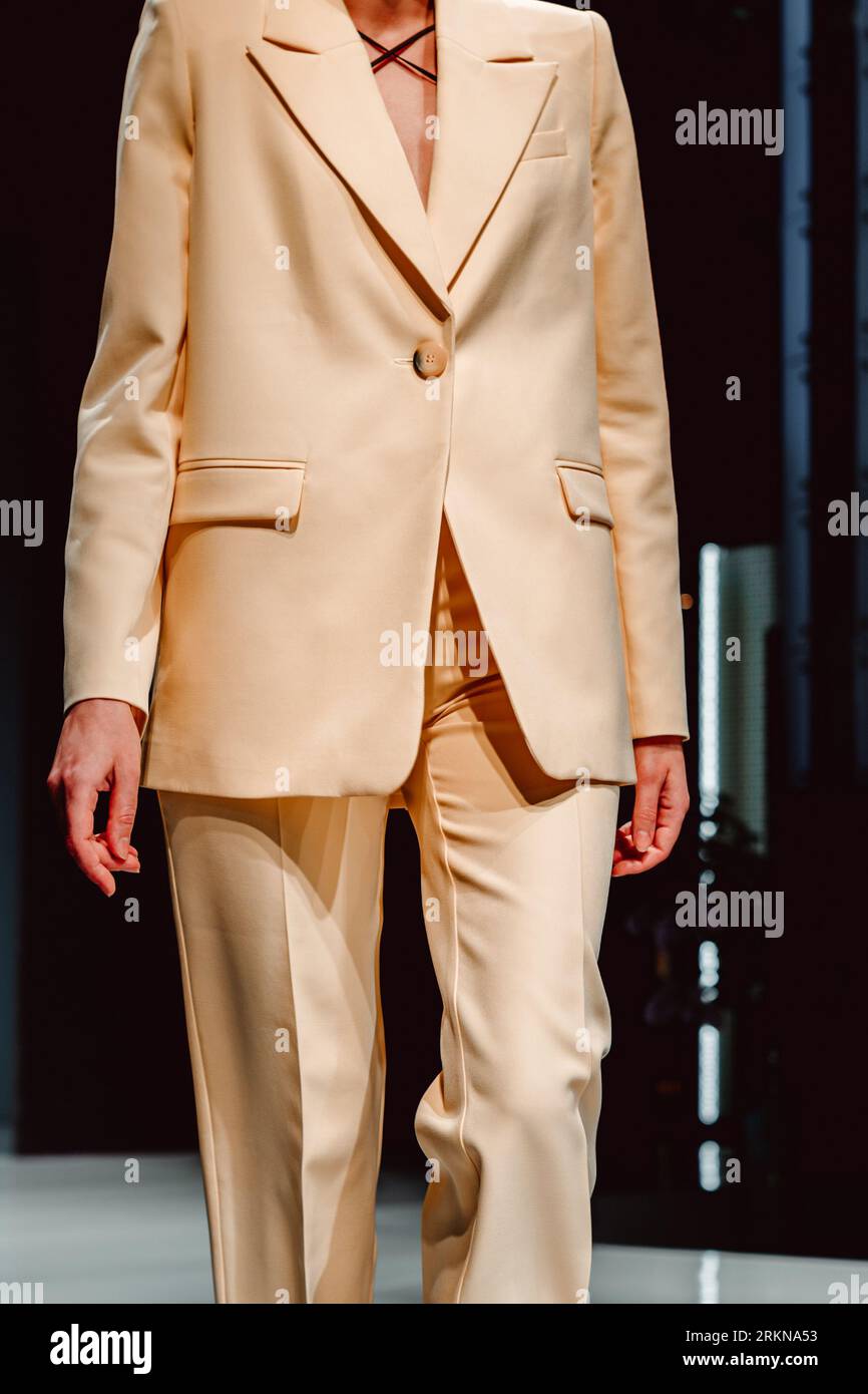 Figure of fashion model woman wearing yellow costume, pants and jacket ...