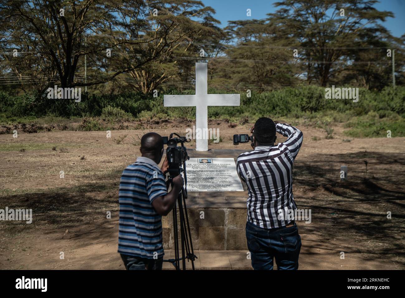 Journalists record a commemorative plaque in memory of Rev. Fr. John ...