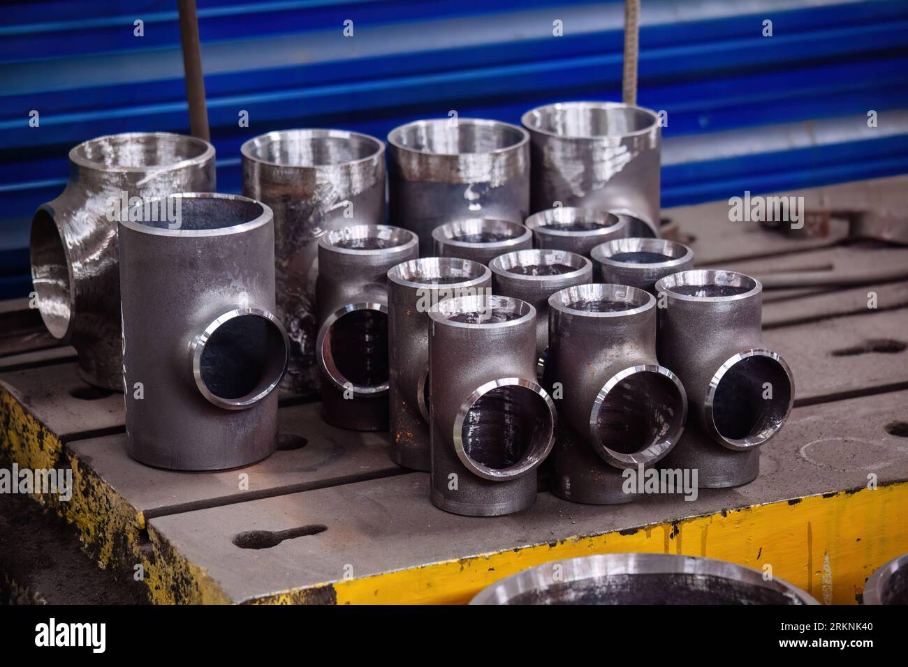Batch of T shape pipe parts in factory Stock Photo - Alamy
