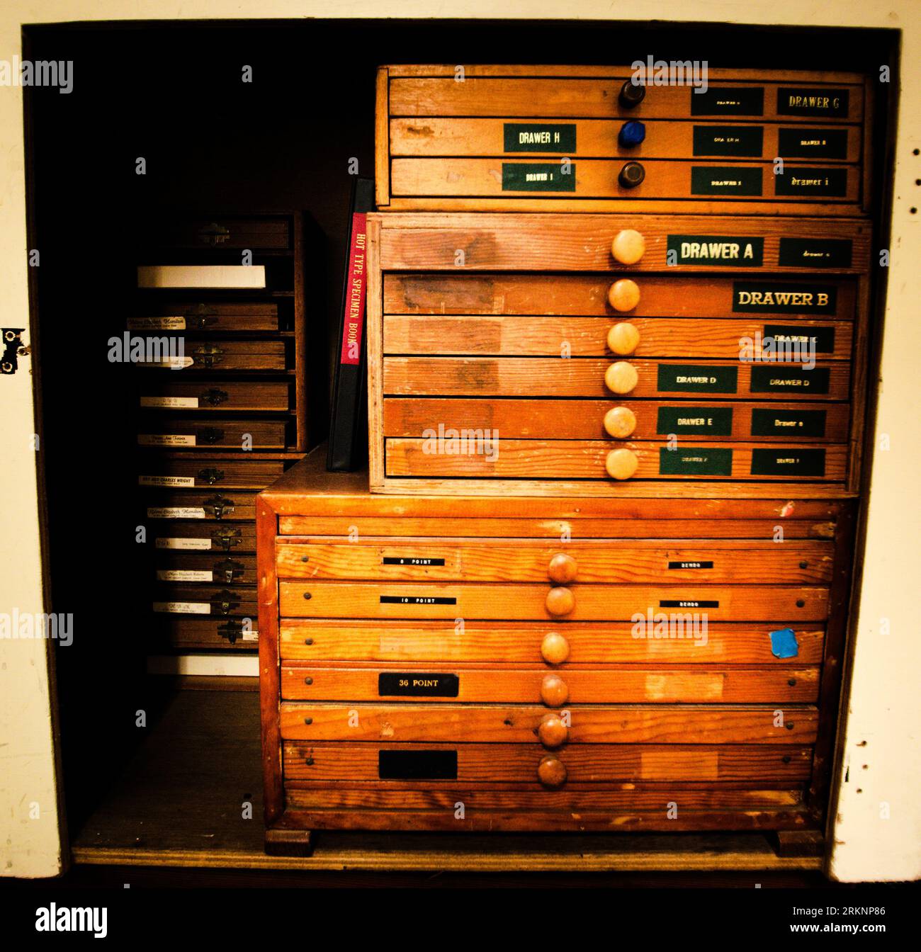 Rows of shelfs containing moveable type and letterpress tools. Iconic ...