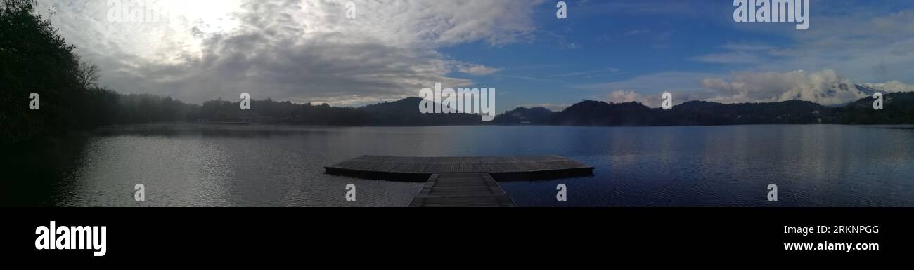 panoramic photo of a romantic wooden jetty on the shore of a lake Stock ...