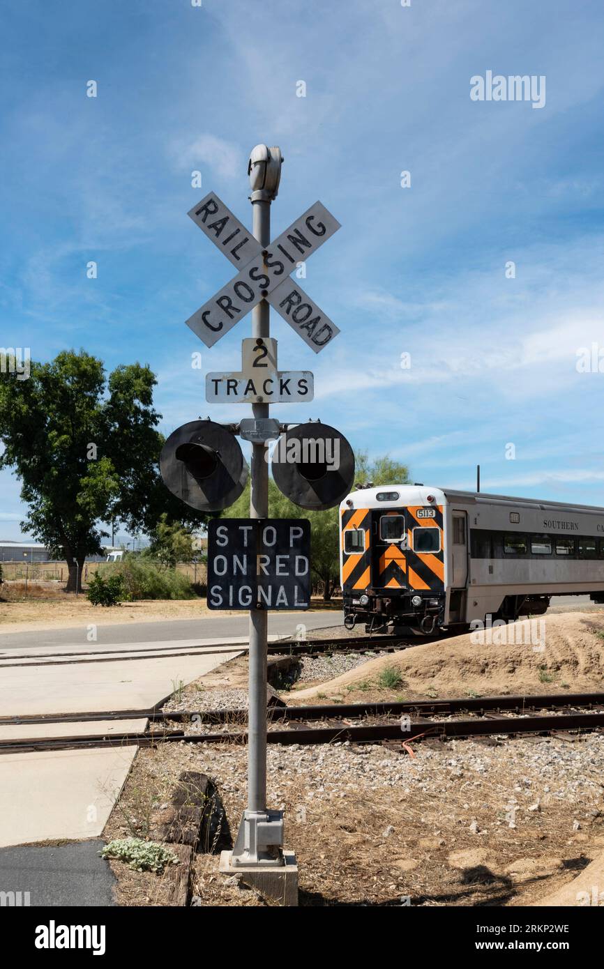 Railroad crossing signal, sign with train in backgroundf Stock Photo ...