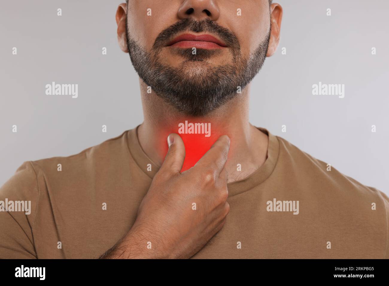 Endocrine system. Man doing thyroid self examination on light grey ...