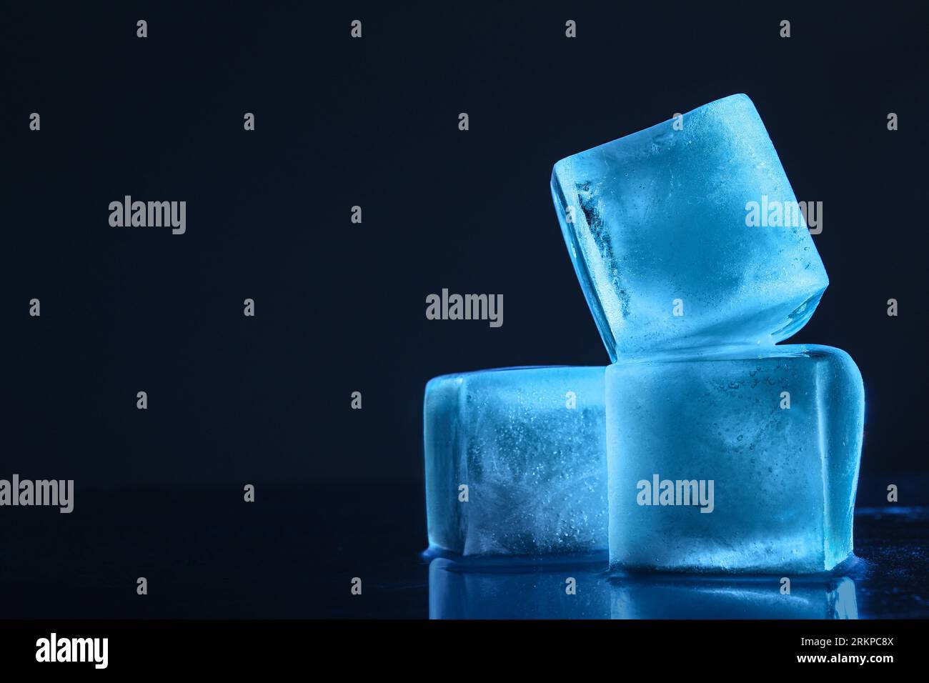 Crystal clear ice cubes on dark background, space for text. Color tone effect Stock Photo - Alamy