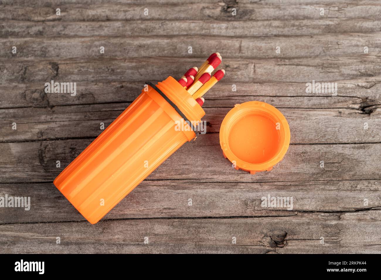 Wooden matches in a watertight container on wooden background Stock ...