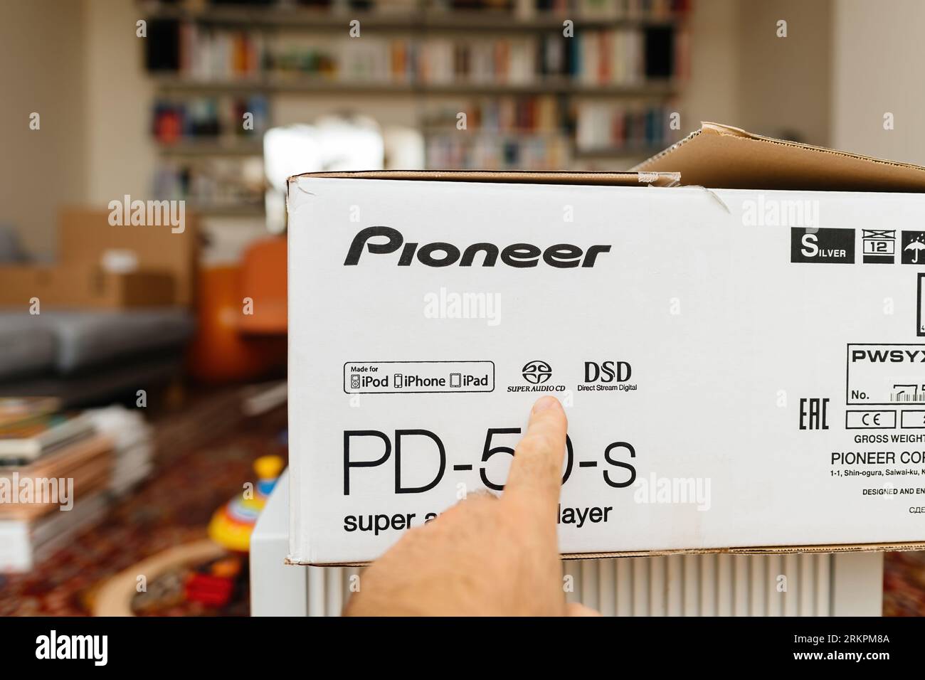 Hamburg, Germany - Jul 24, 2023: POV male hand pointing to the Super Audio CD signage next to ...