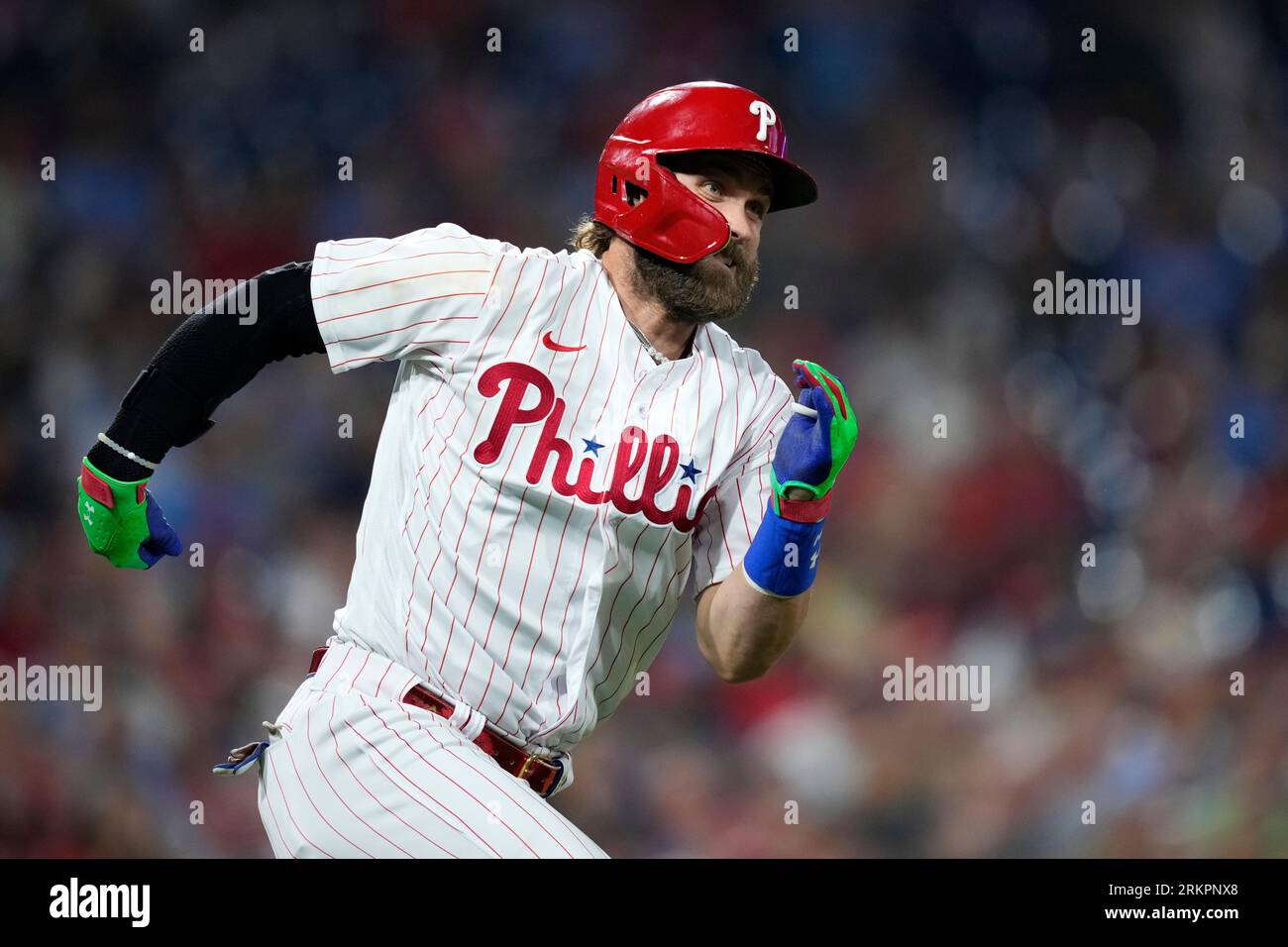 Philadelphia Phillies' Bryce Harper runs after hitting a triple against ...