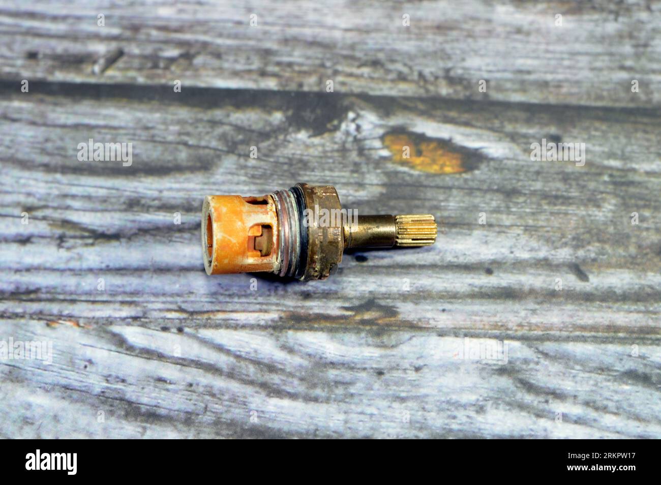 A used shower faucet tap body cartridge parts of plastic and copper ...