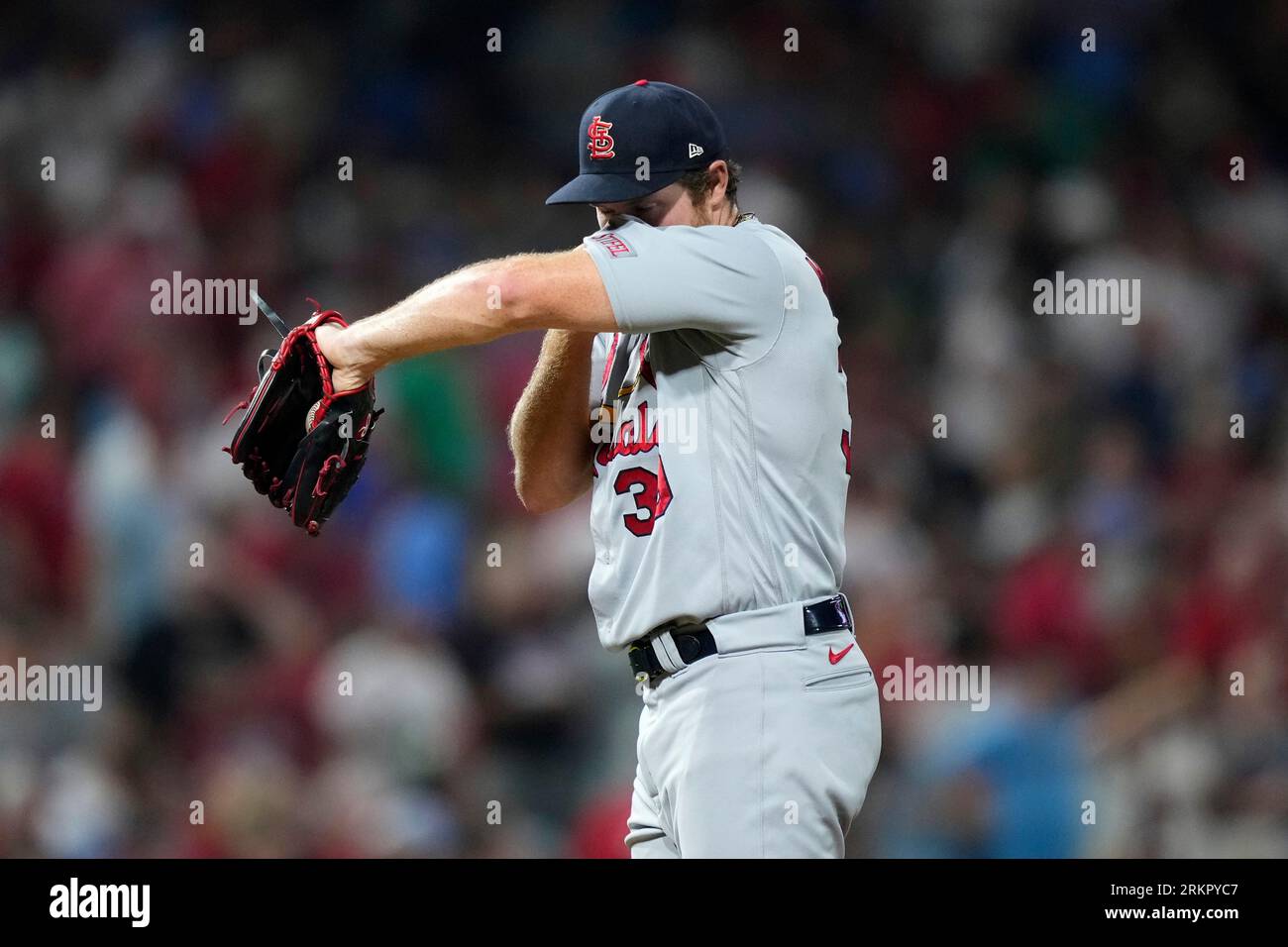 St. Louis Cardinals pitcher Miles Mikolas wipes his face after giving ...