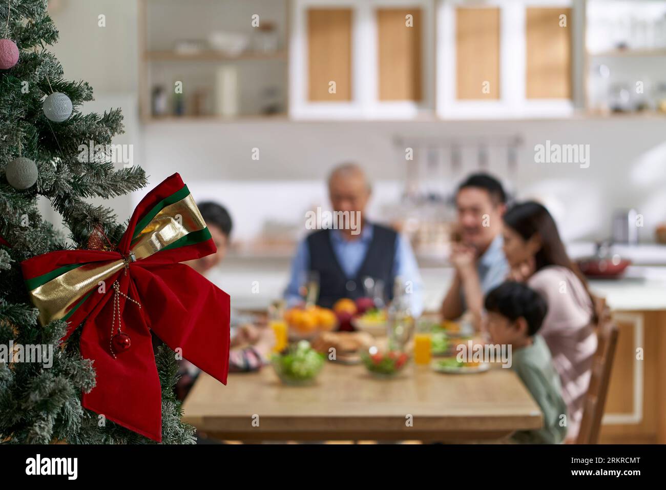 multi generational asian family gathering together having meal on ...