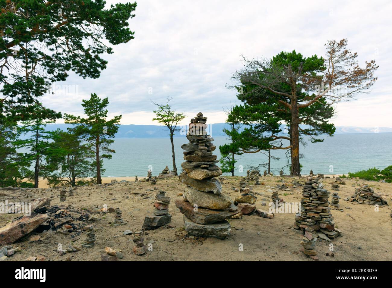 Zen Pyramid Stones and Larches on the Baikal Sand Beach Stock Photo - Alamy