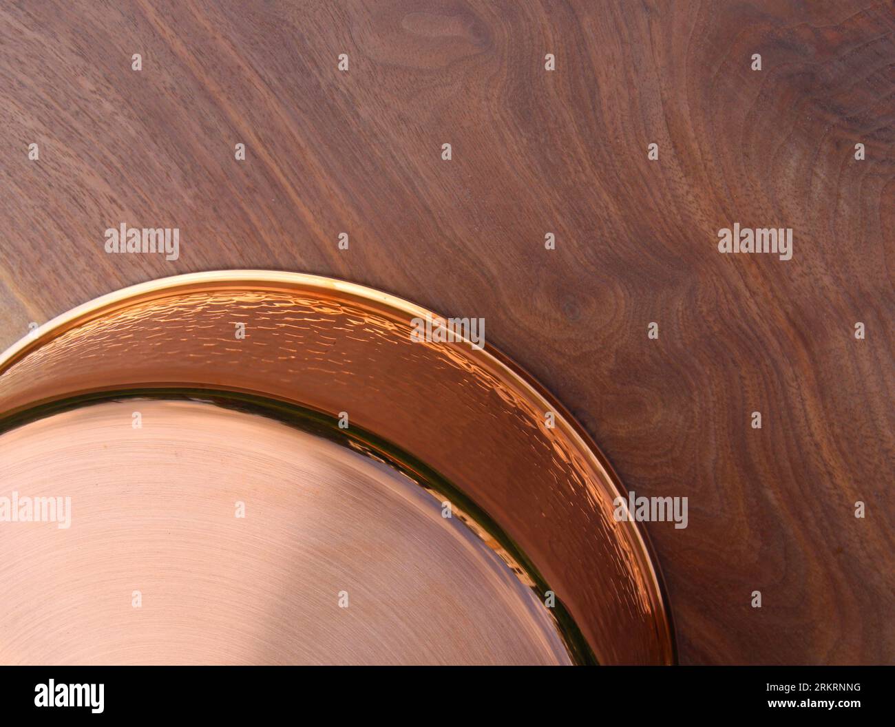 A Shiny Hammered Copper Pot on a Black Walnut Wood Background Stock ...