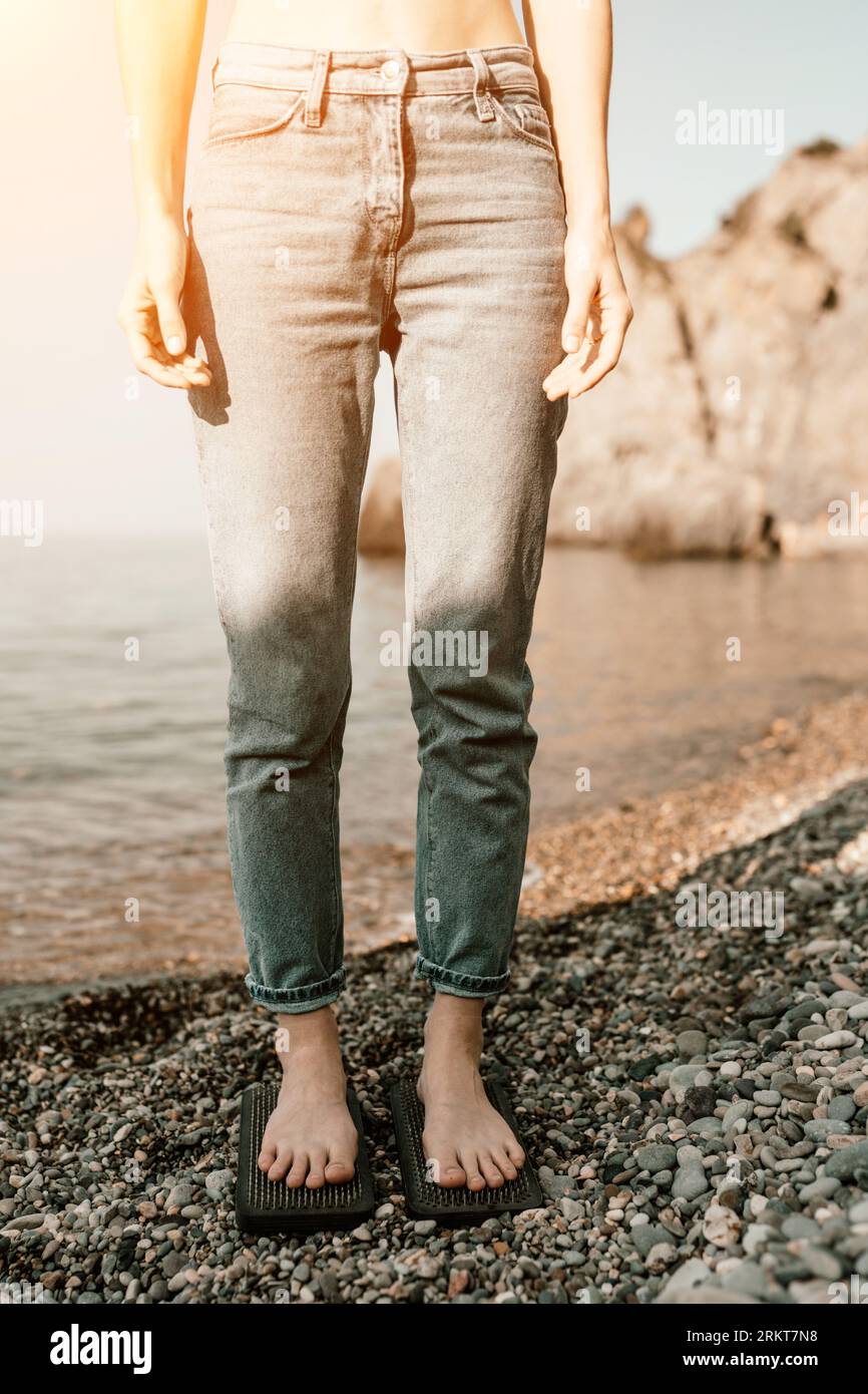 Sea Woman feet stepping on sadhu board during indian practice on the ...