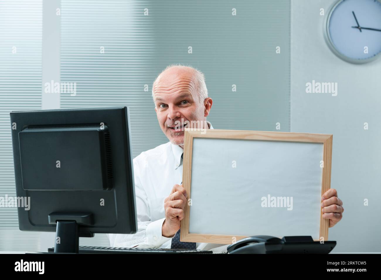 Mature businessman, passionate about his firsthand experience, shows a ...