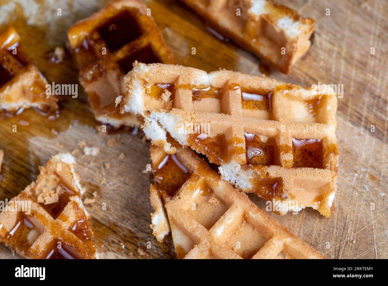 square sweet soft waffles in bee honey , a traditional European dessert ...