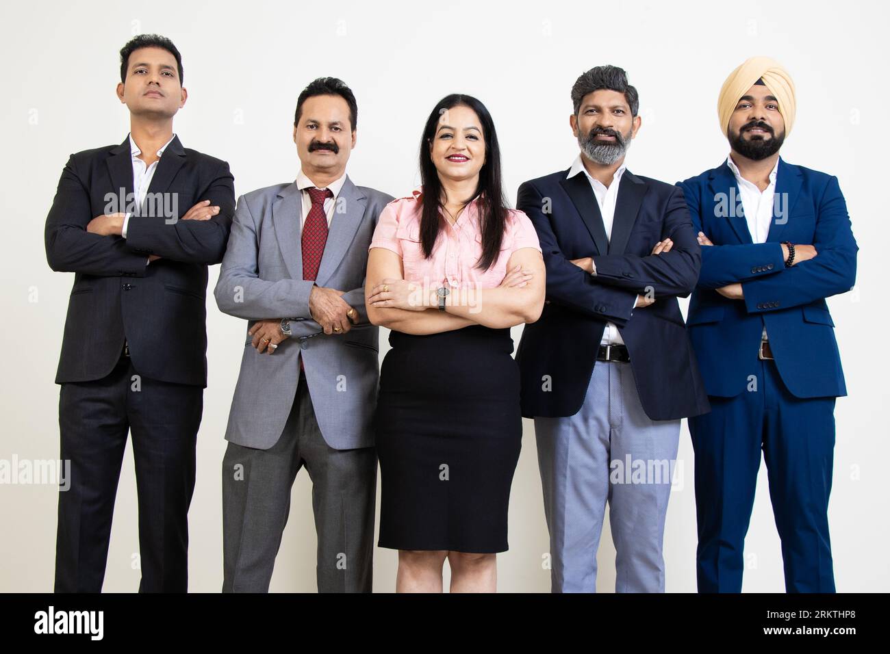 Group of positive indian business people wearing suit standing cross ...