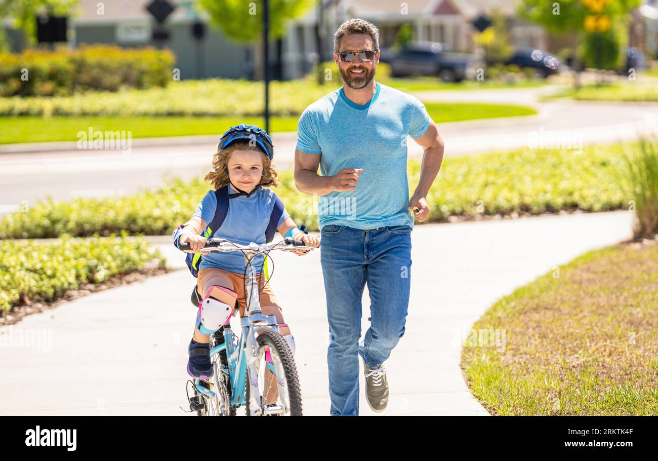 father and son on bicycle at fathers day. active father setting a ...
