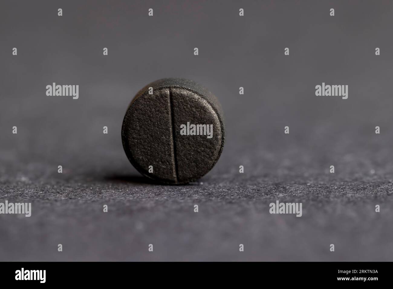Open and unpacked tablets of black color close-up, several of the same ...