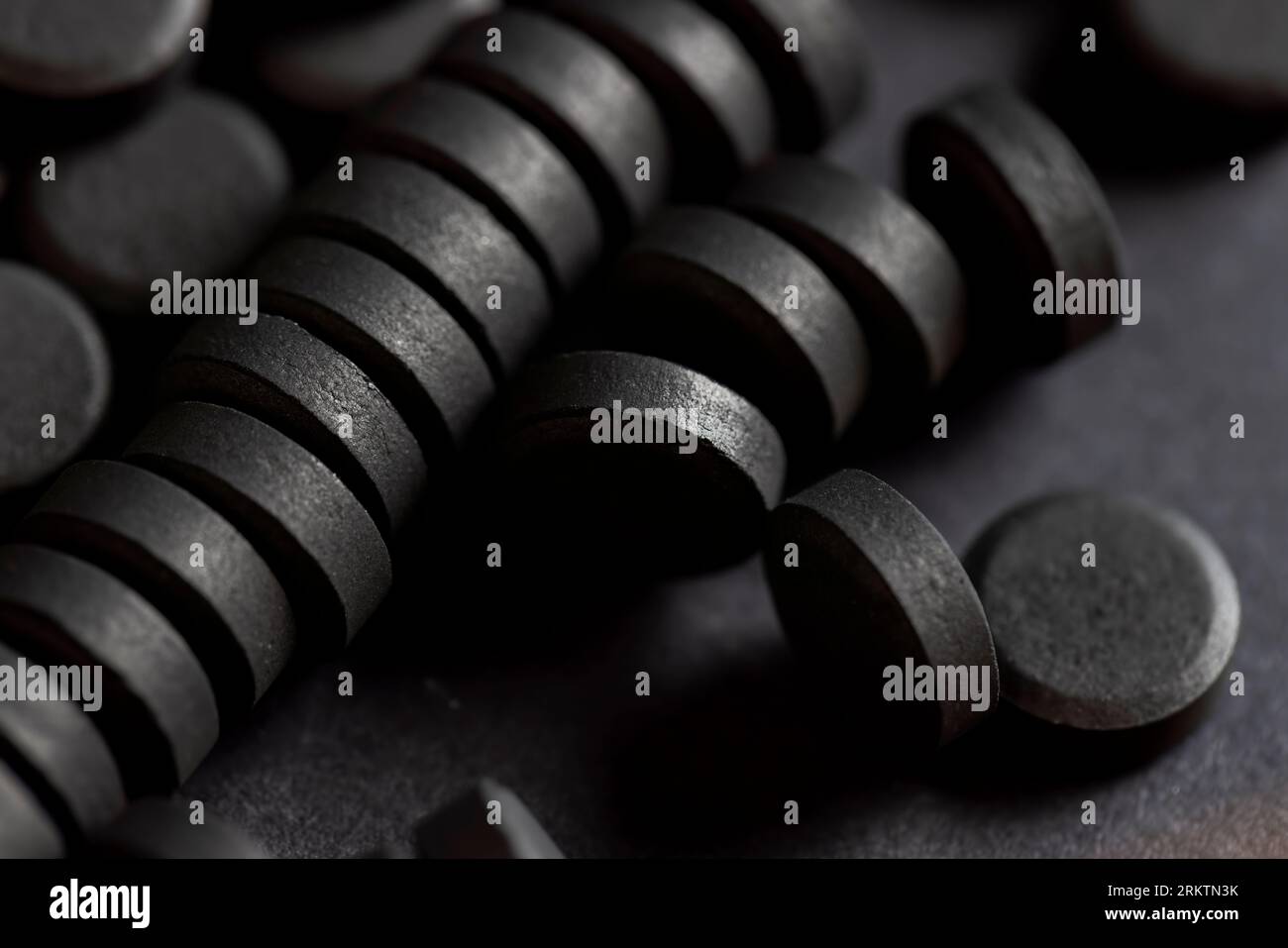 Open and unpacked tablets of black color close-up, several of the same ...
