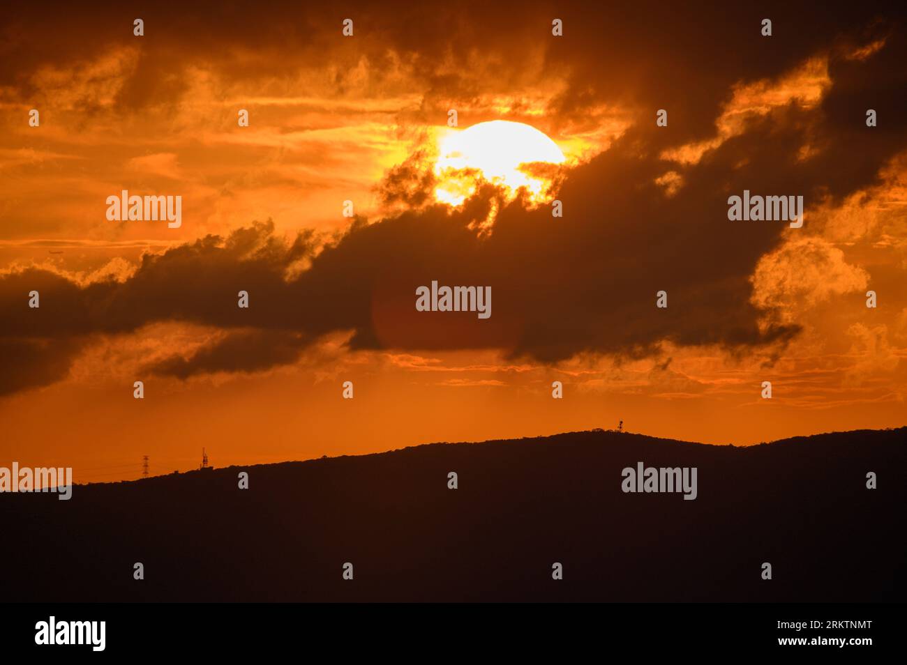 At dusk, the sun is sometimes covered by dark clouds and sometimes ...