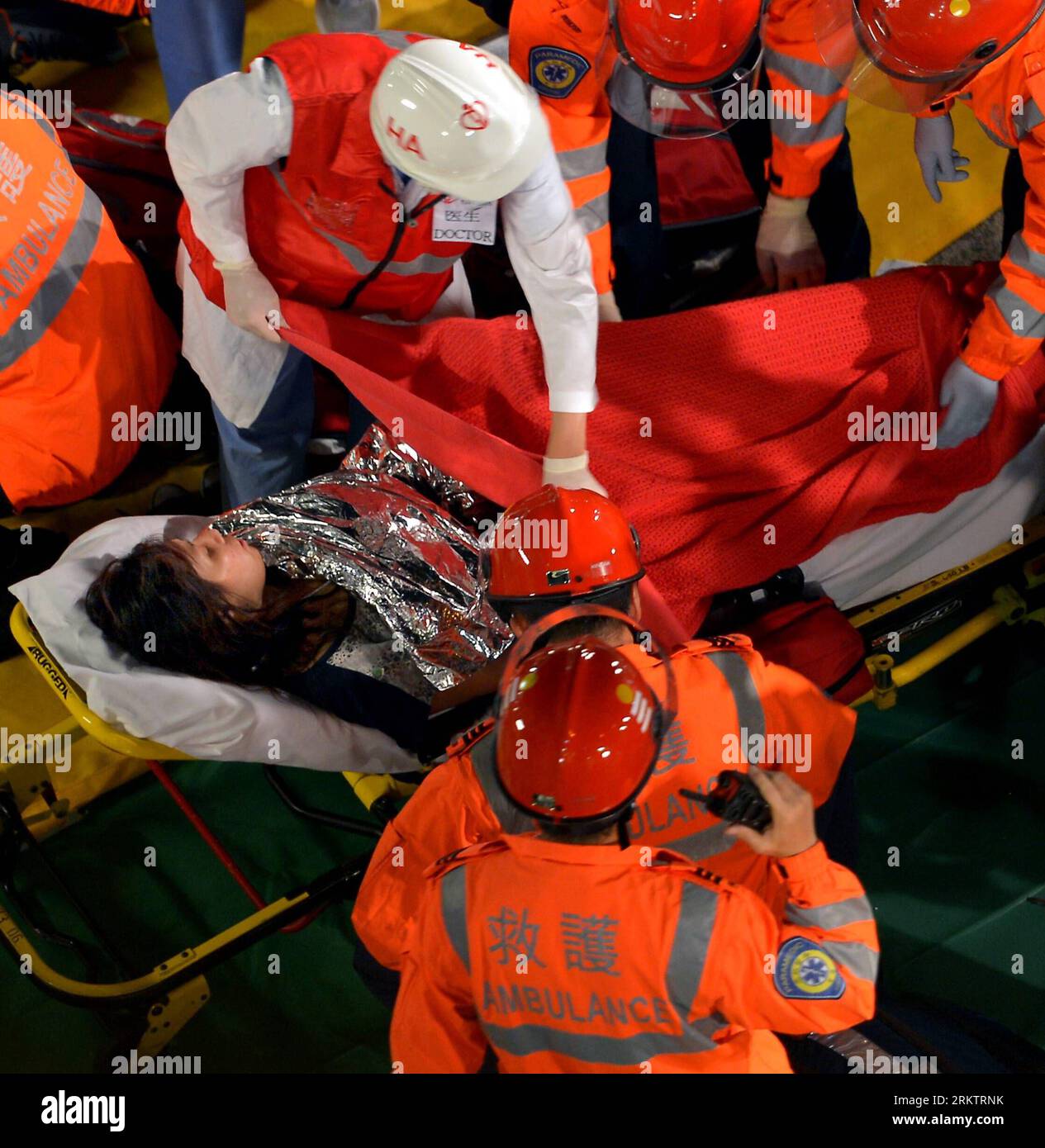 Unconscious victim carried hi-res stock photography and images - Alamy