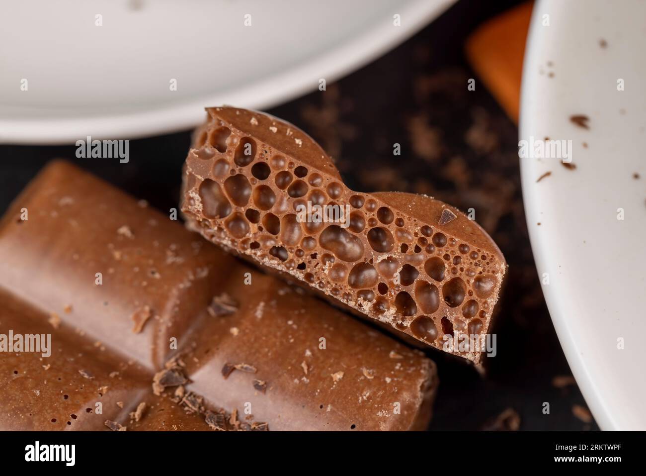 A piece of chocolate bar with air bubbles, chocolate bar made of cocoa ...