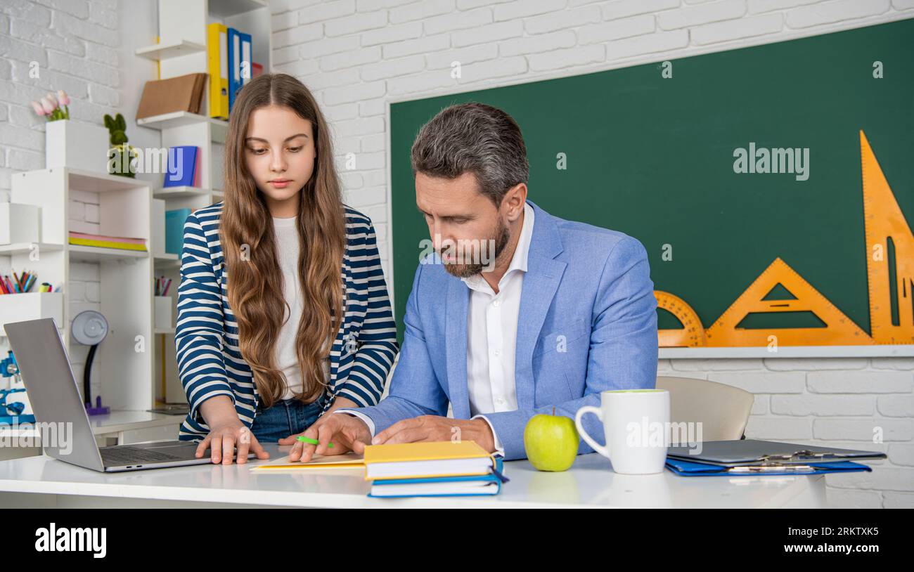 curious child study in classroom with teacher Stock Photo - Alamy
