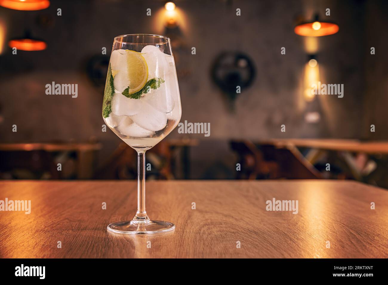 Glass of refreshing alcohol gin tonic cocktail with sliced cucumber and ...