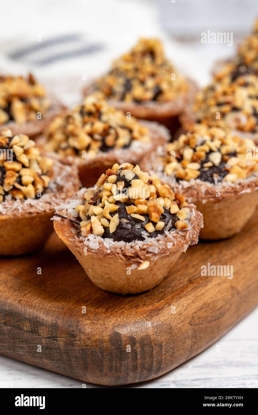 Tart cookies. Delicious mini tartlets with chocolate cream and nuts on ...