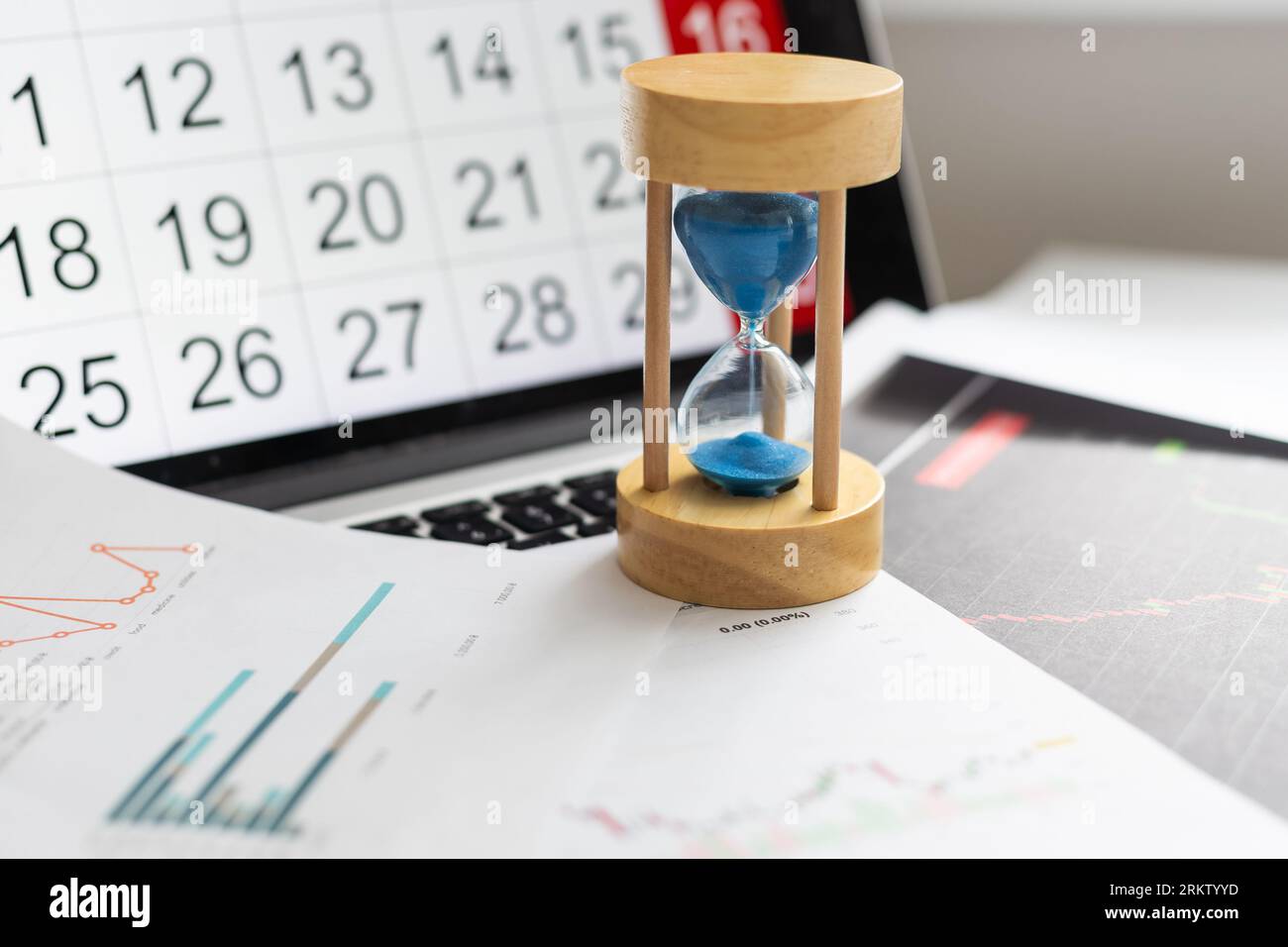 Hourglass and calendar on bright background Stock Photo - Alamy