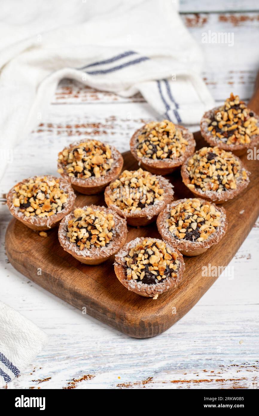 Tart cookies. Delicious mini tartlets with chocolate cream and nuts on ...