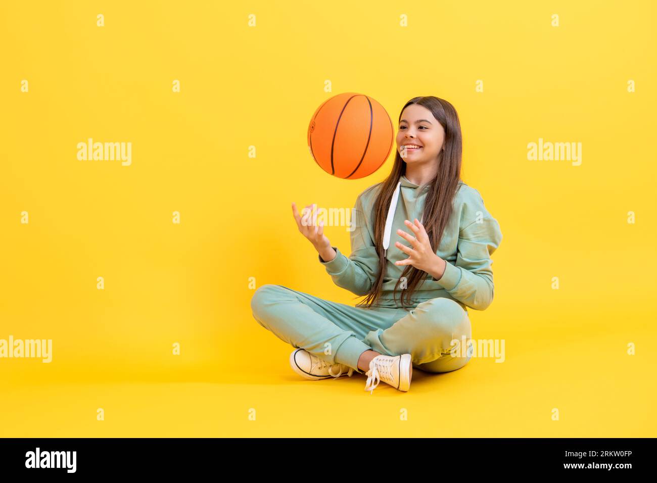 Teen girl excelling in basketball. Skilled teen girl playing the ...