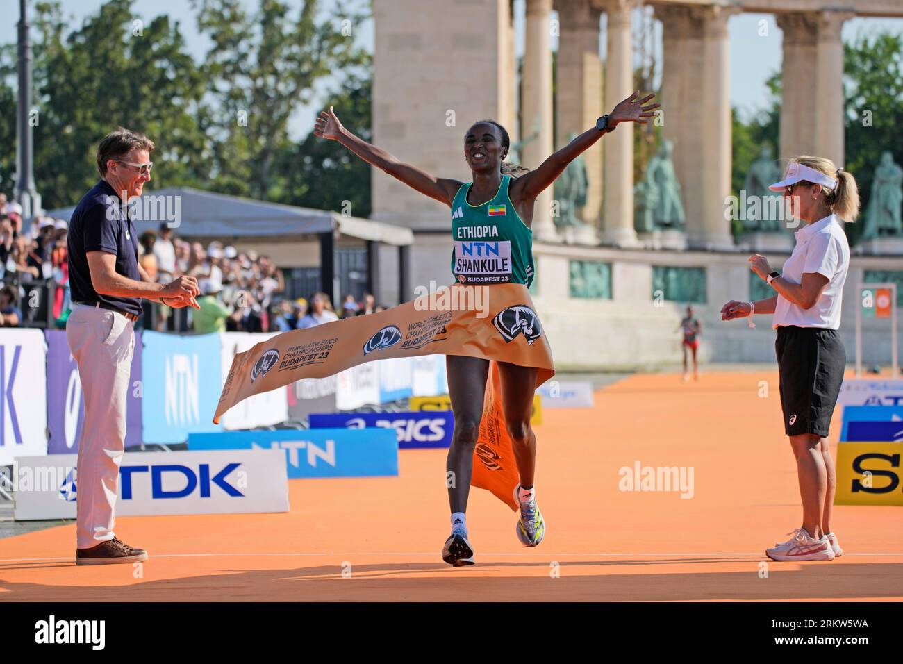 Amane Beriso Shankule of Ethiopia reacts as she crosses the finish line ...