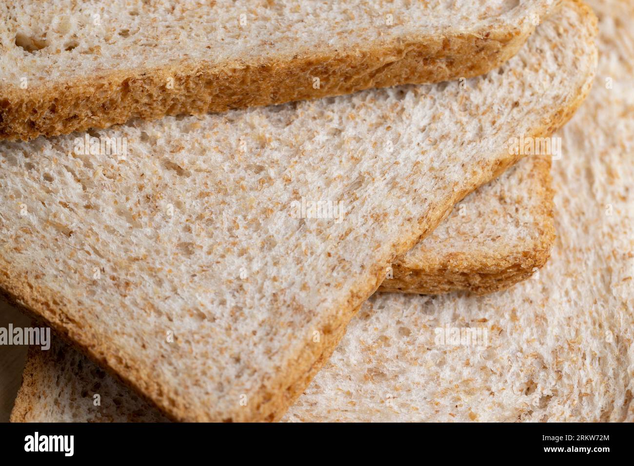 Square loaf of light wheat bread cut into pieces, sliced wheat bread ...