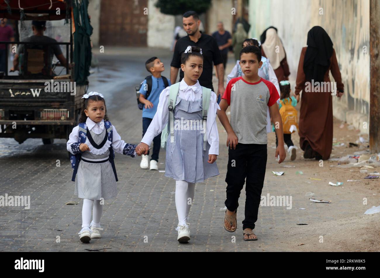 Palestinian refugee children walk at Rafah in the southern Gaza Strip ...