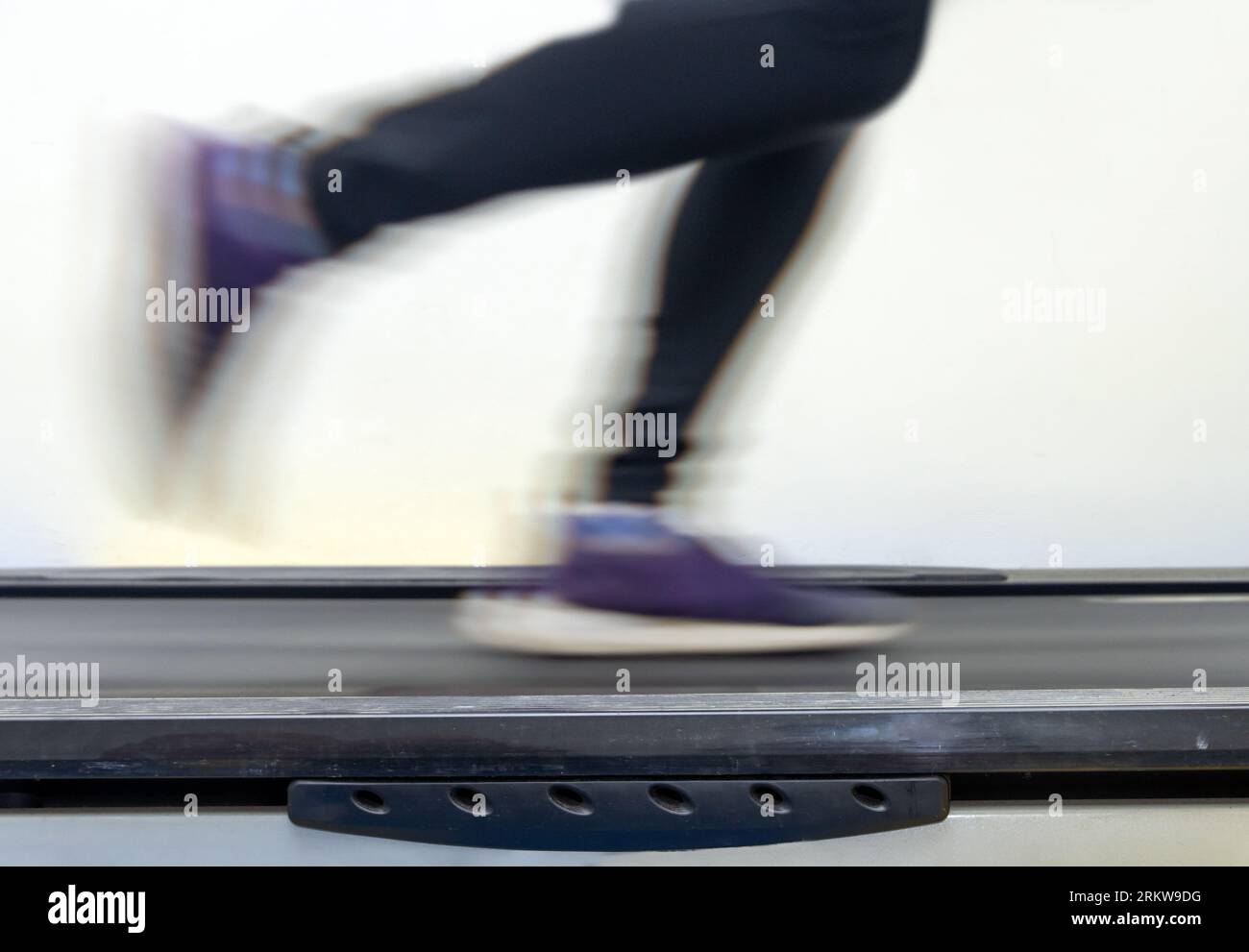 Moving legs of a runner on a treadmill Stock Photo - Alamy
