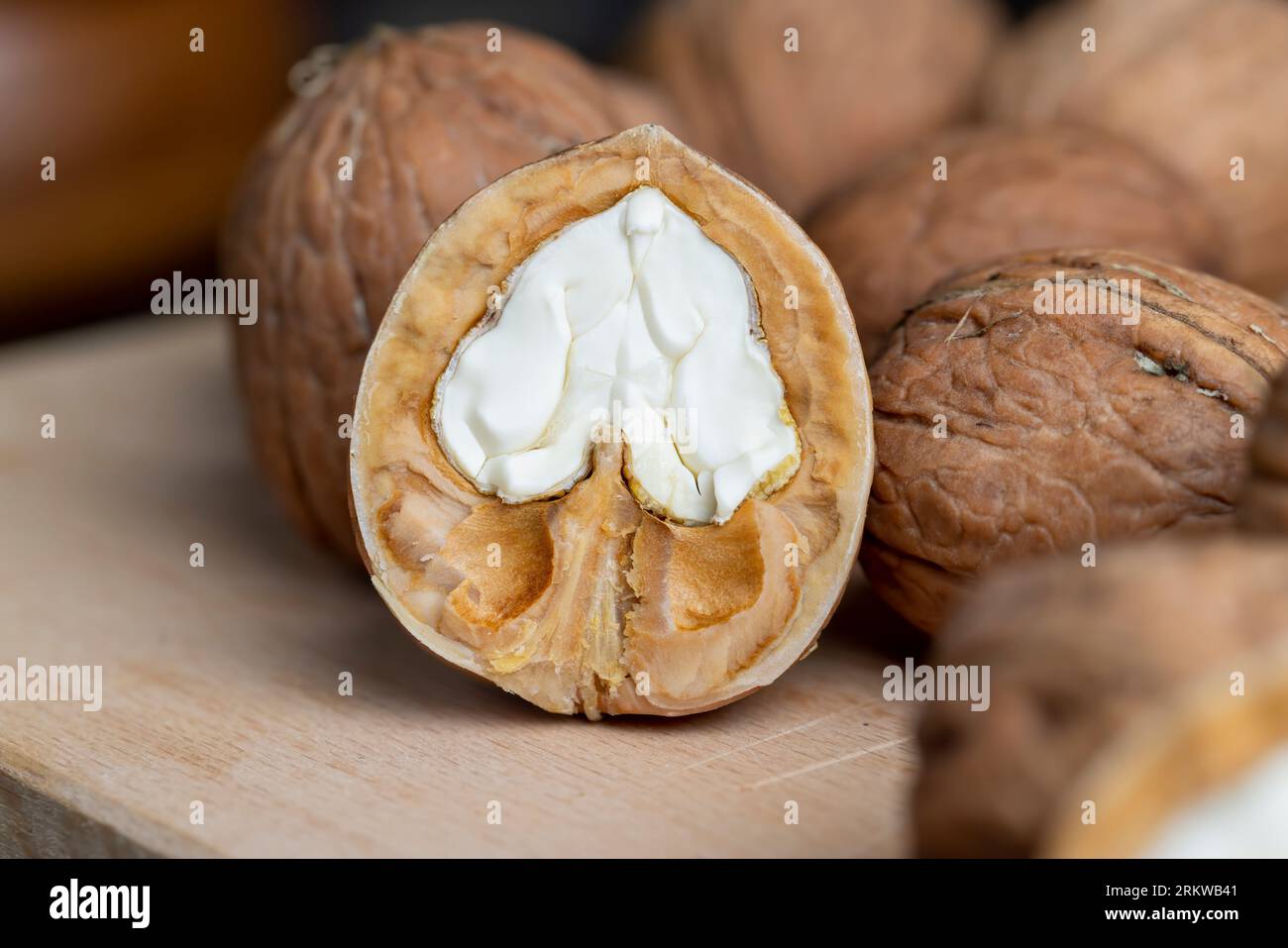 Open and broken walnut shells lying on the table , soft fresh and not ...